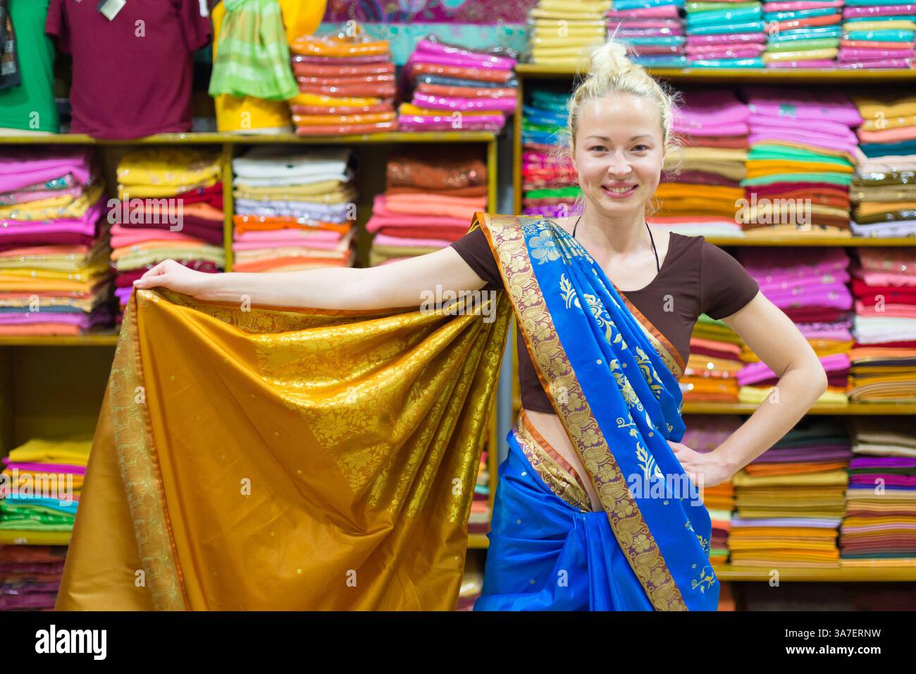 Travel photo of beautiful blond Caucasian tourist woman trying to wear ...