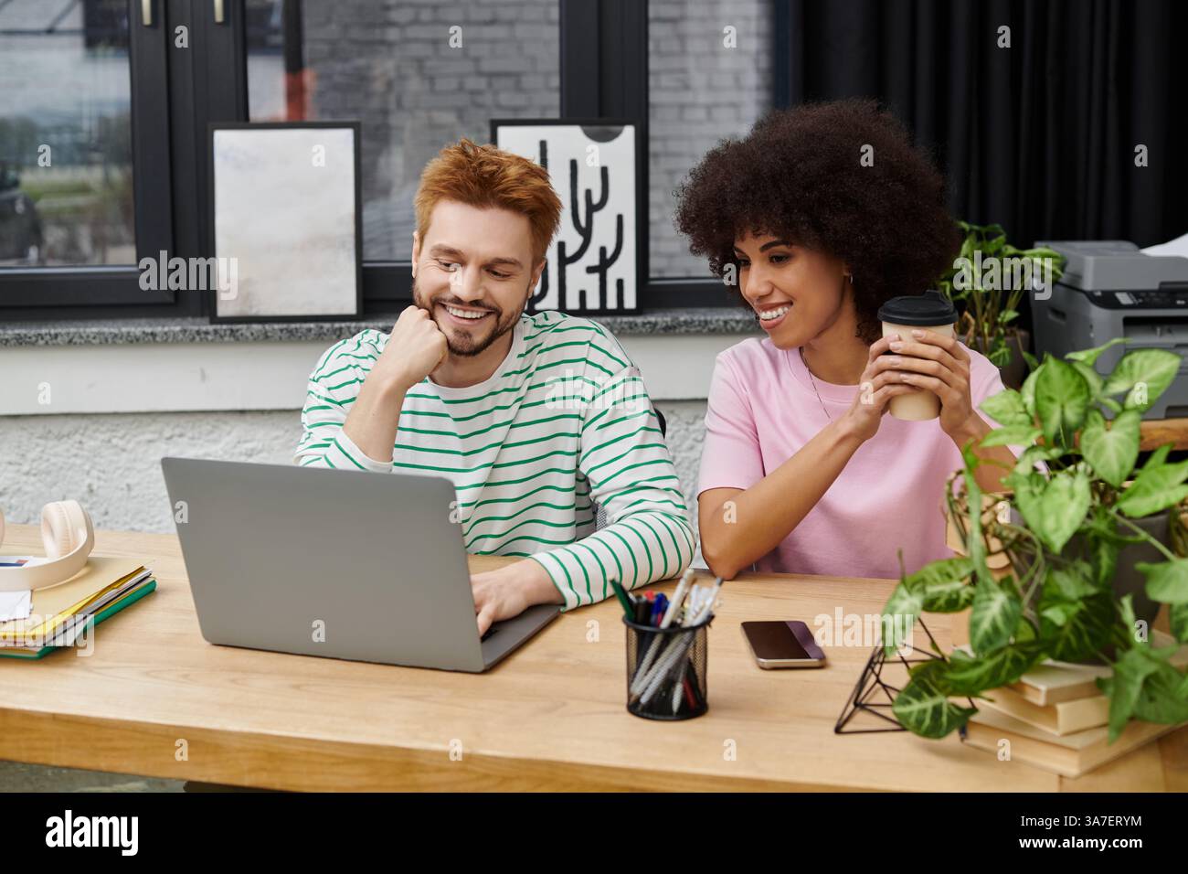 Two friends collaborate on moving tasks in a stylish workspace ...