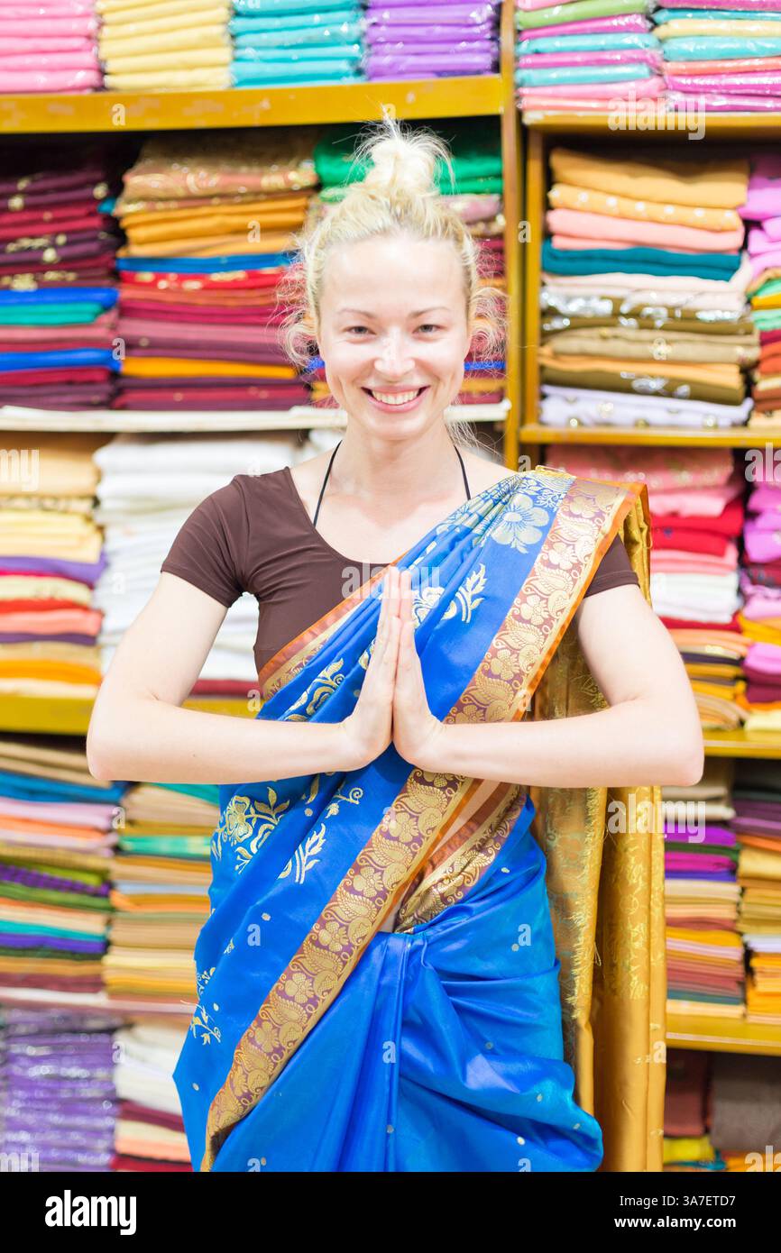 Travel photo of beautiful blond Caucasian tourist woman trying to wear ...