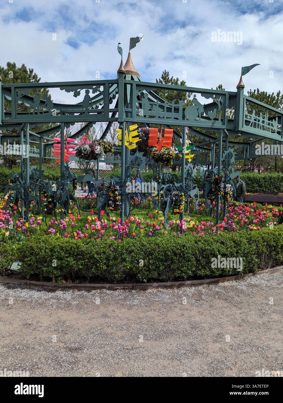 Colorful Garden Carousel Surrounded by Vibrant Tulips and Blooming ...