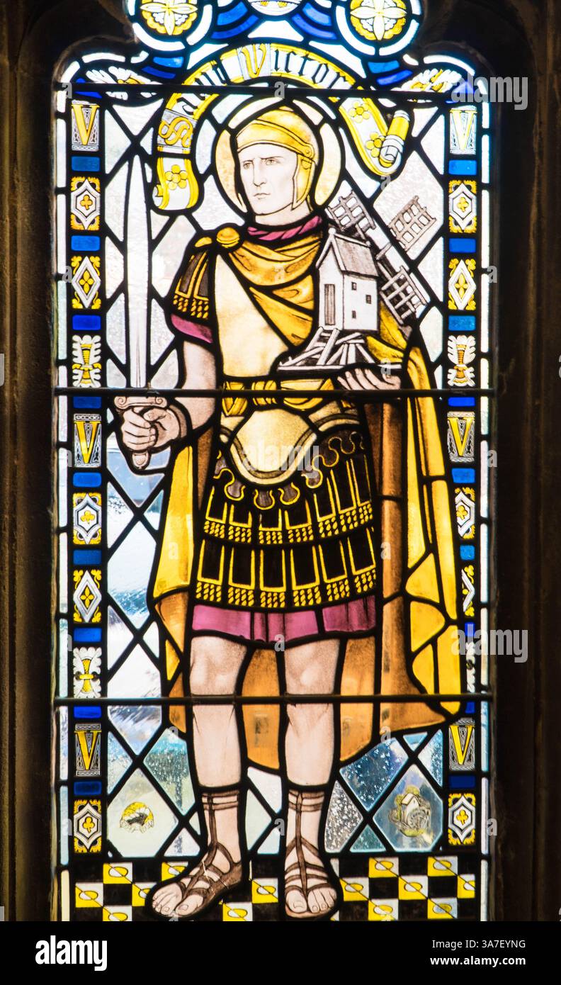 Stained glass depicting St Victor holding a sword in his right hand and ...