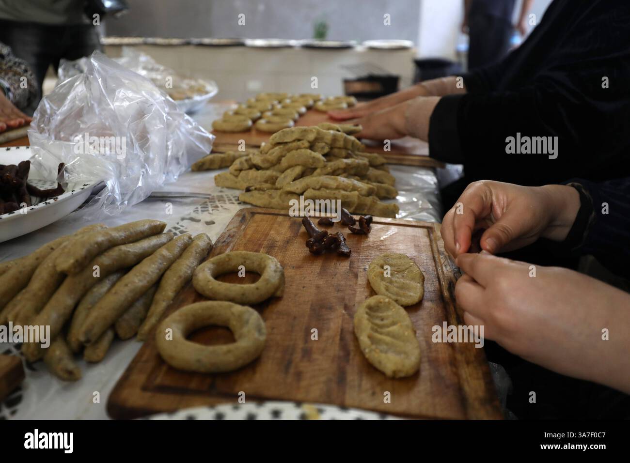 Palestinian families prepare the traditional cookies ahead of Eid al ...