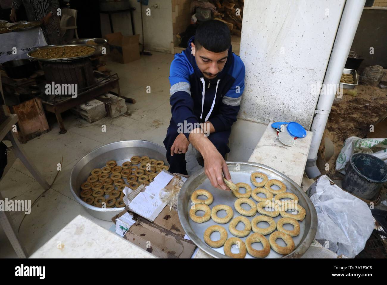 Palestinian families prepare the traditional cookies ahead of Eid al ...