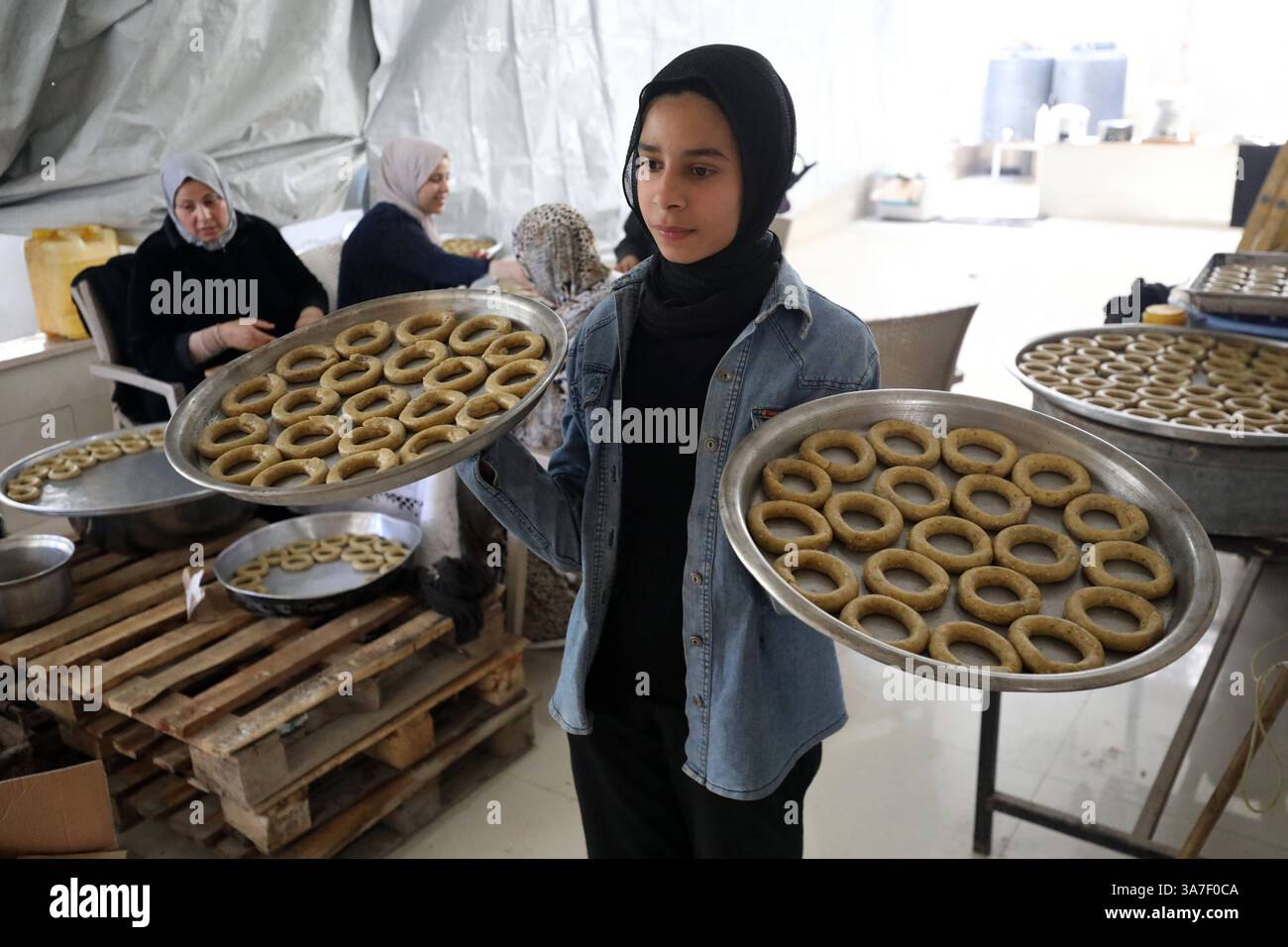 Palestinian families prepare the traditional cookies ahead of Eid al ...