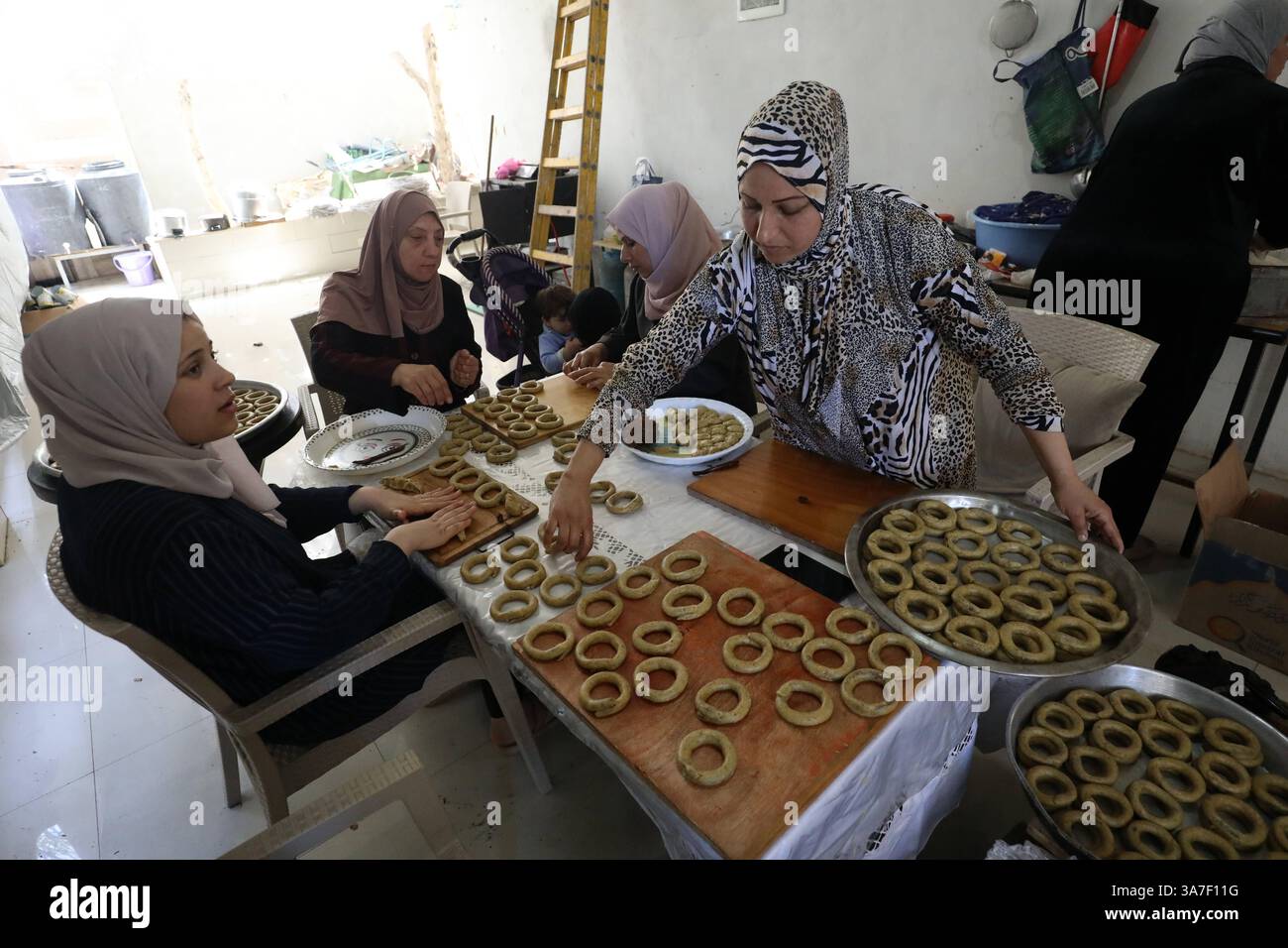 Palestinian families prepare the traditional cookies ahead of Eid al ...