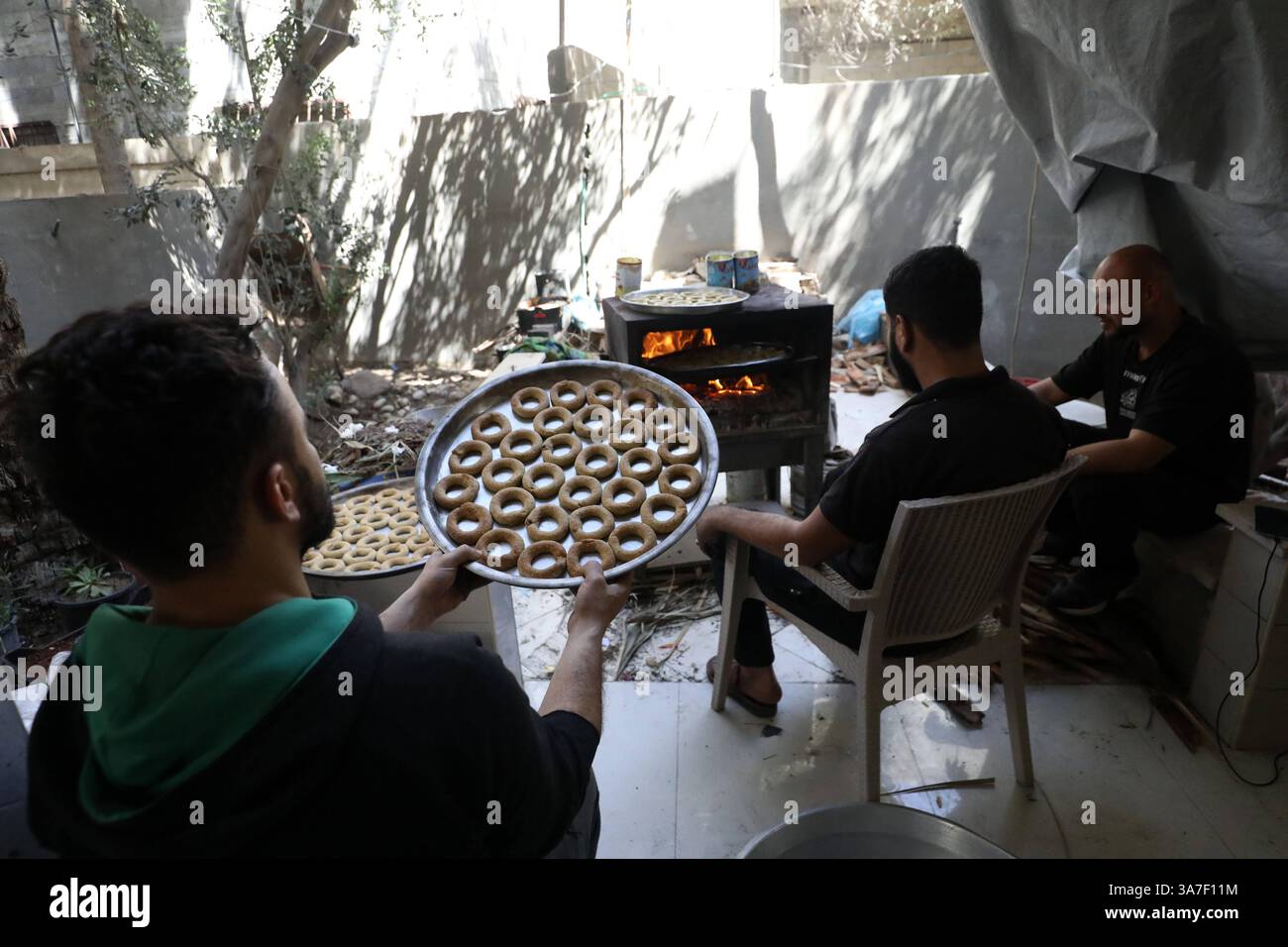 Palestinian families prepare the traditional cookies ahead of Eid al ...