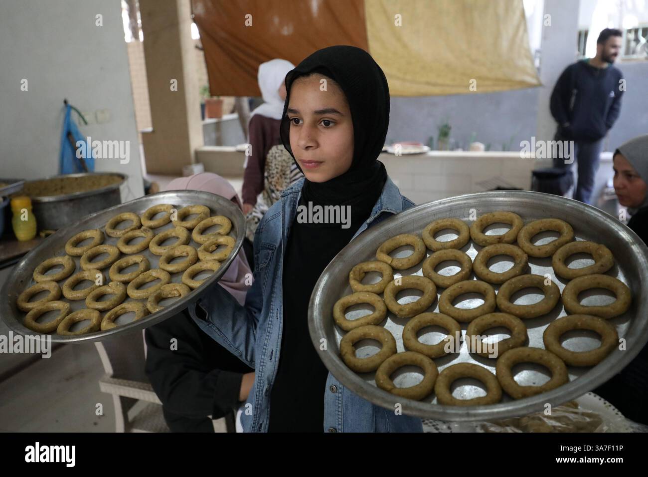 Palestinian families prepare the traditional cookies ahead of Eid al ...