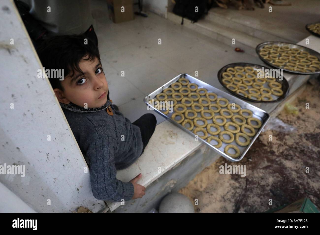 Palestinian families prepare the traditional cookies ahead of Eid al ...