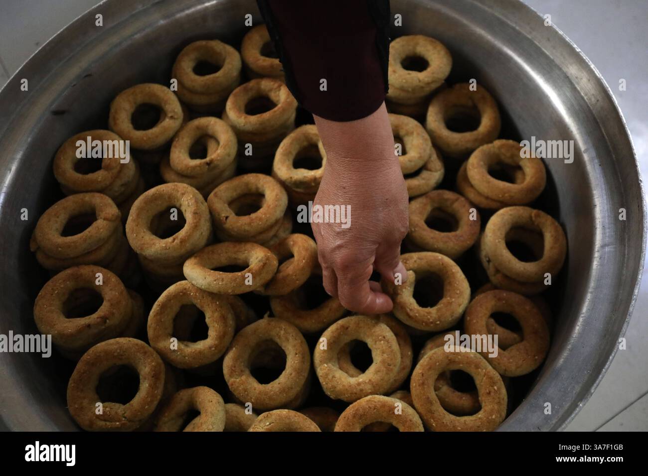 Palestinian families prepare the traditional cookies ahead of Eid al ...