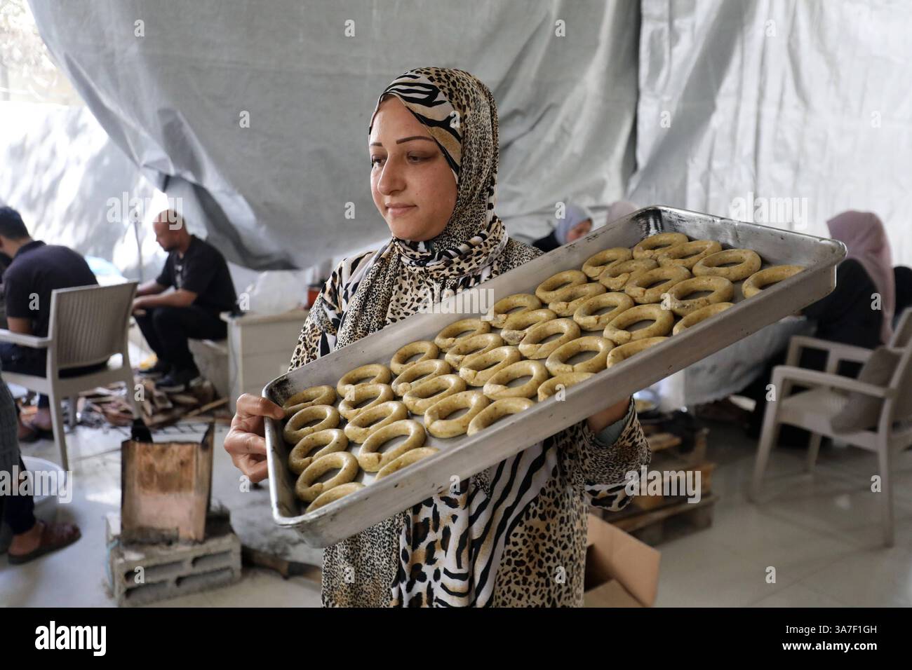 Palestinian families prepare the traditional cookies ahead of Eid al ...
