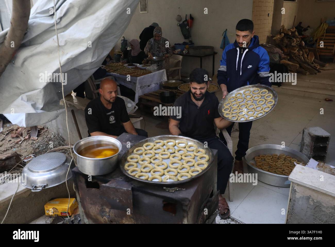 Palestinian families prepare the traditional cookies ahead of Eid al ...
