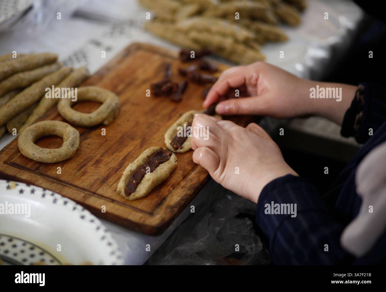 Palestinian families prepare the traditional cookies ahead of Eid al ...