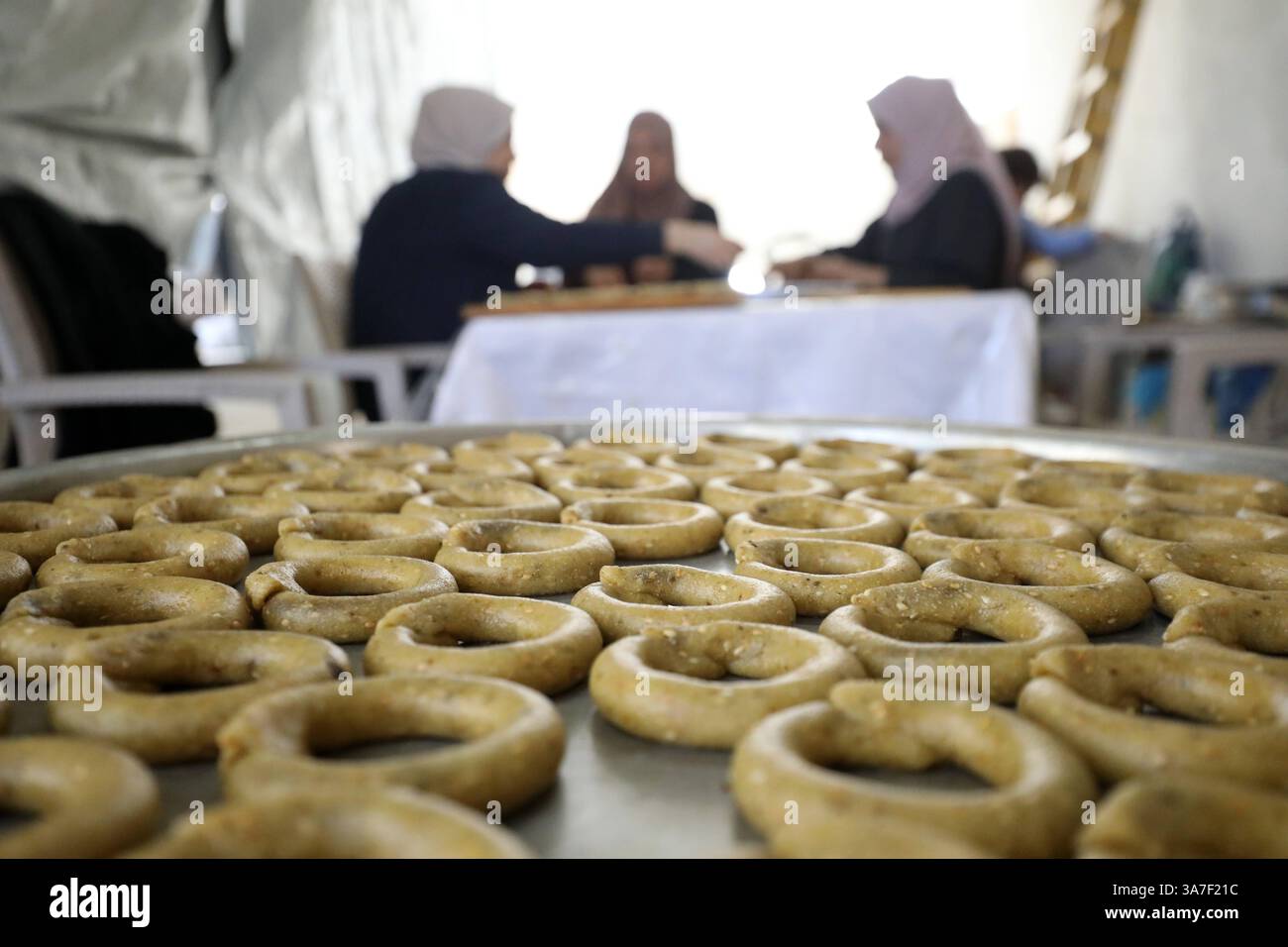 Palestinian families prepare the traditional cookies ahead of Eid al ...