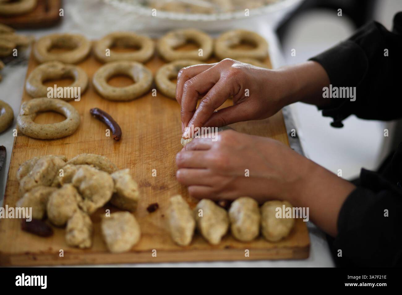 Palestinian families prepare the traditional cookies ahead of Eid al ...