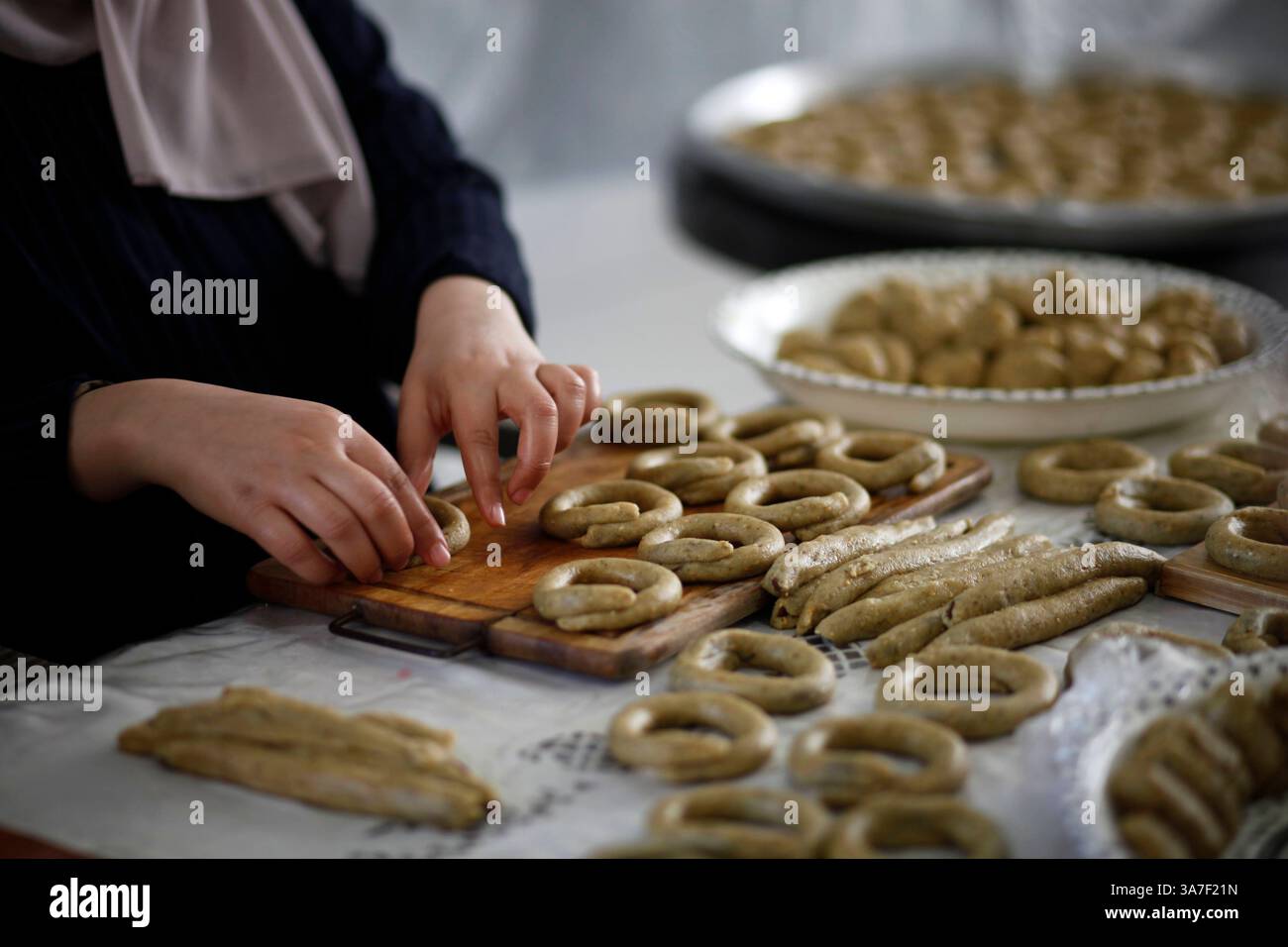 Palestinian families prepare the traditional cookies ahead of Eid al ...