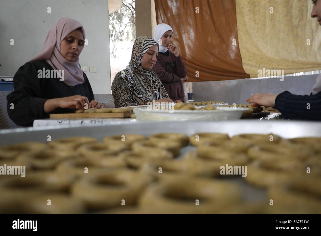Palestinian families prepare the traditional cookies ahead of Eid al ...