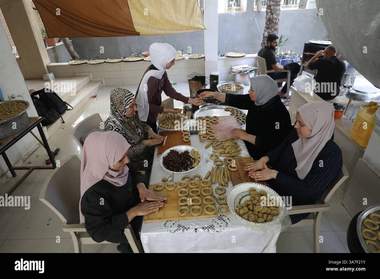 Palestinian families prepare the traditional cookies ahead of Eid al ...