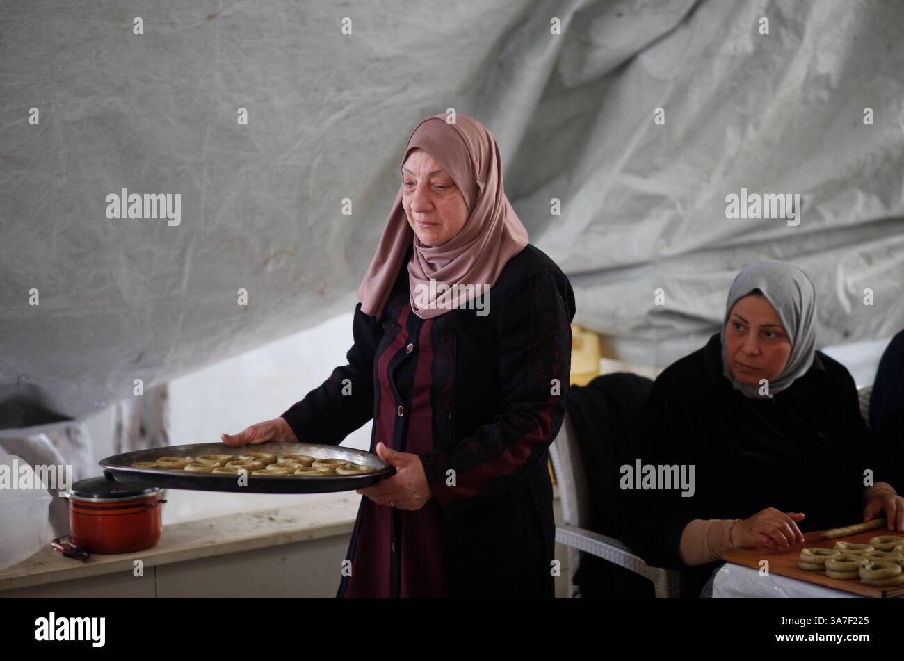 Palestinian families prepare the traditional cookies ahead of Eid al ...