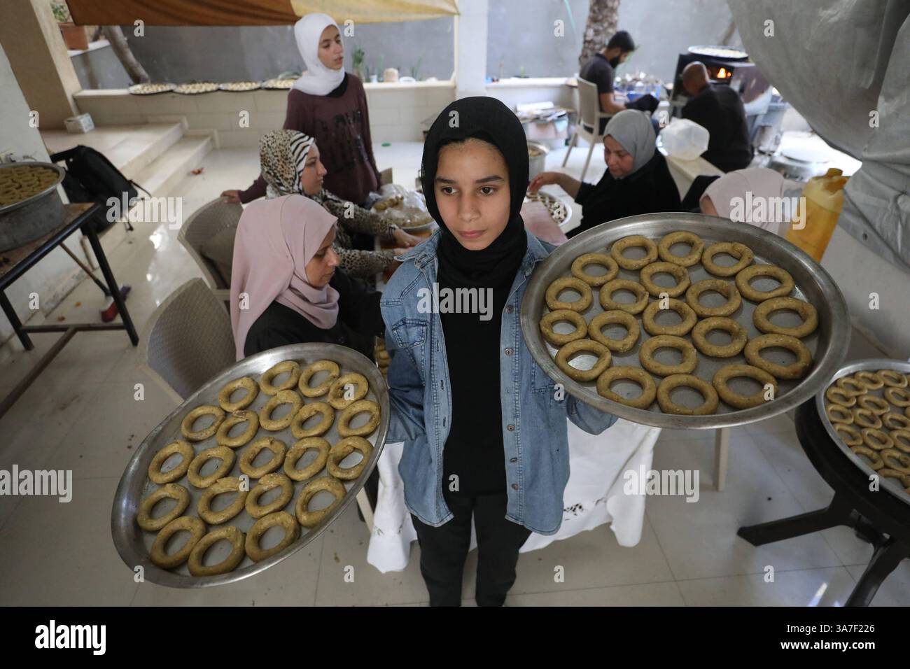 Palestinian families prepare the traditional cookies ahead of Eid al ...
