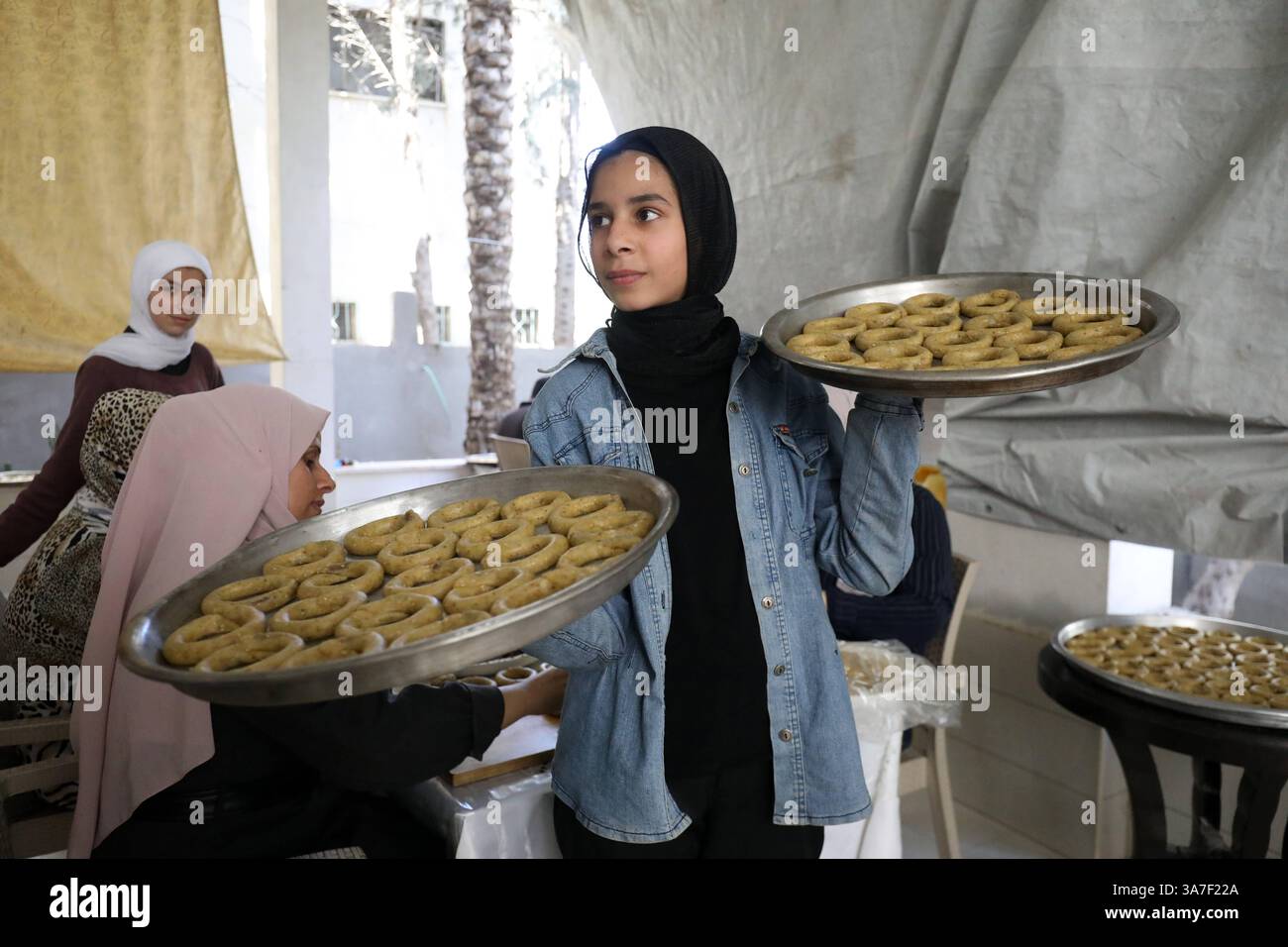 Palestinian families prepare the traditional cookies ahead of Eid al ...