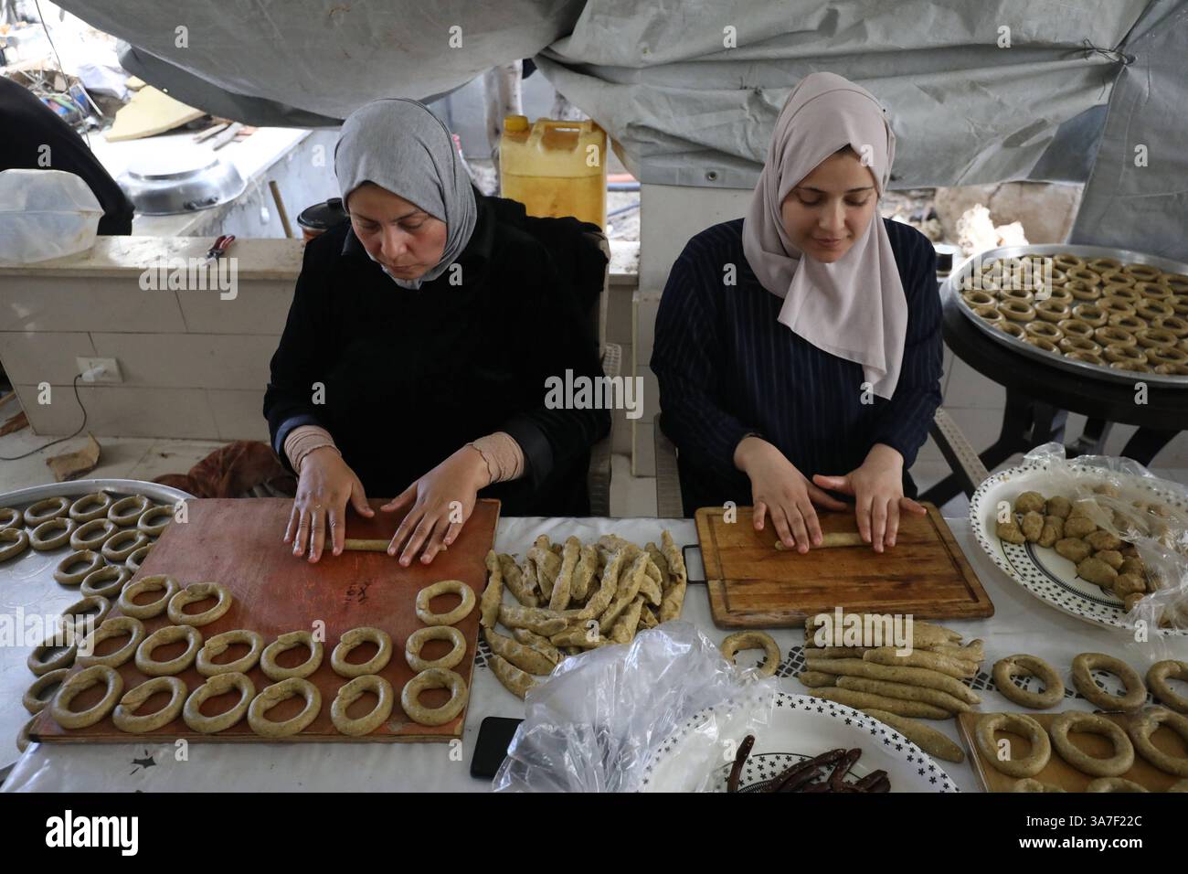 Palestinian families prepare the traditional cookies ahead of Eid al ...