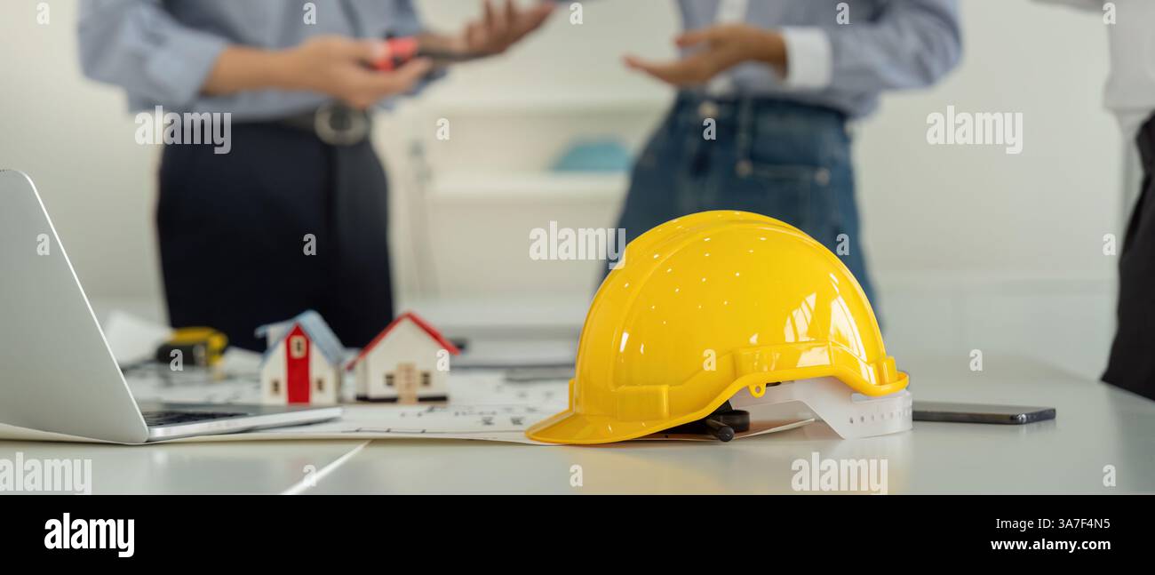 Project Discussion and Safety Gear. A construction helmet symbolizing ...