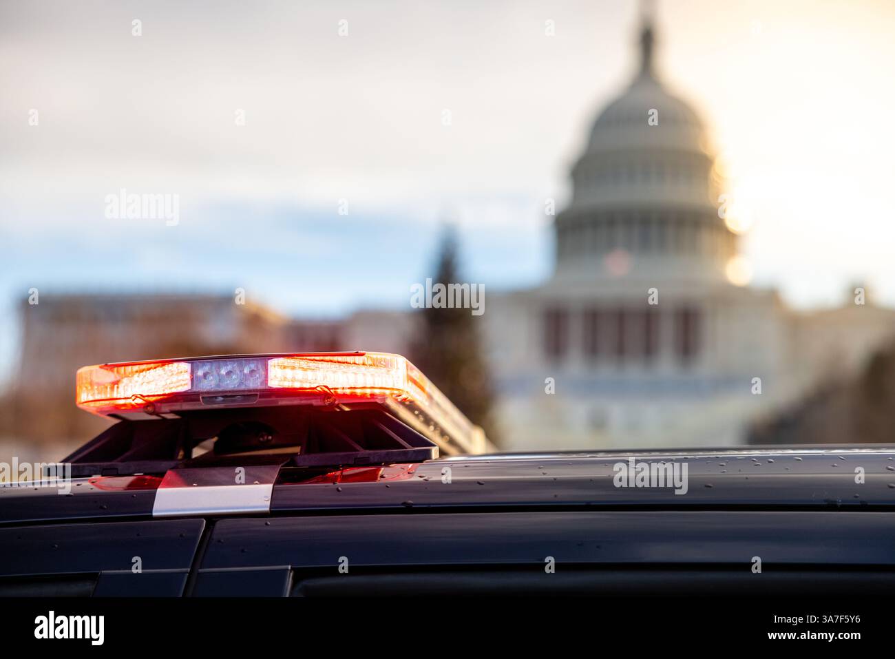A light bar on a Capitol Police cruiser is illuminated, with an out of focus US Capitol in the ...