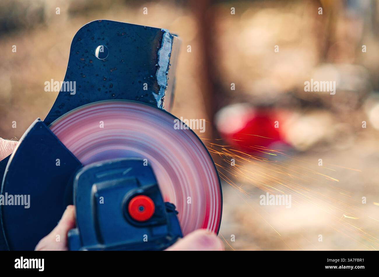 Hand using angle grinder to cut metal with sparks in outdoor construction site Stock Photo - Alamy