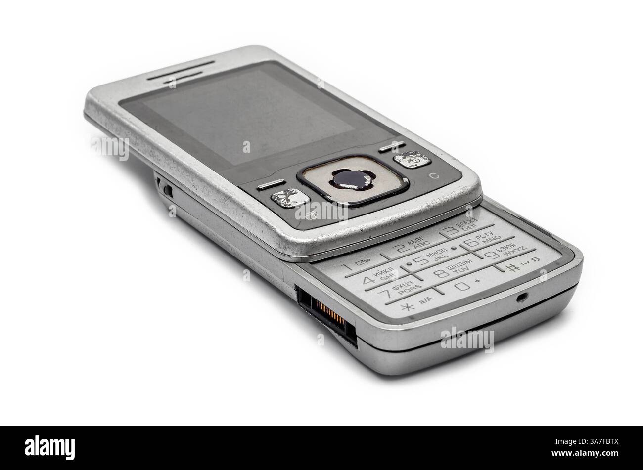 Vintage open flip mobile phone with keypad on white background for ...