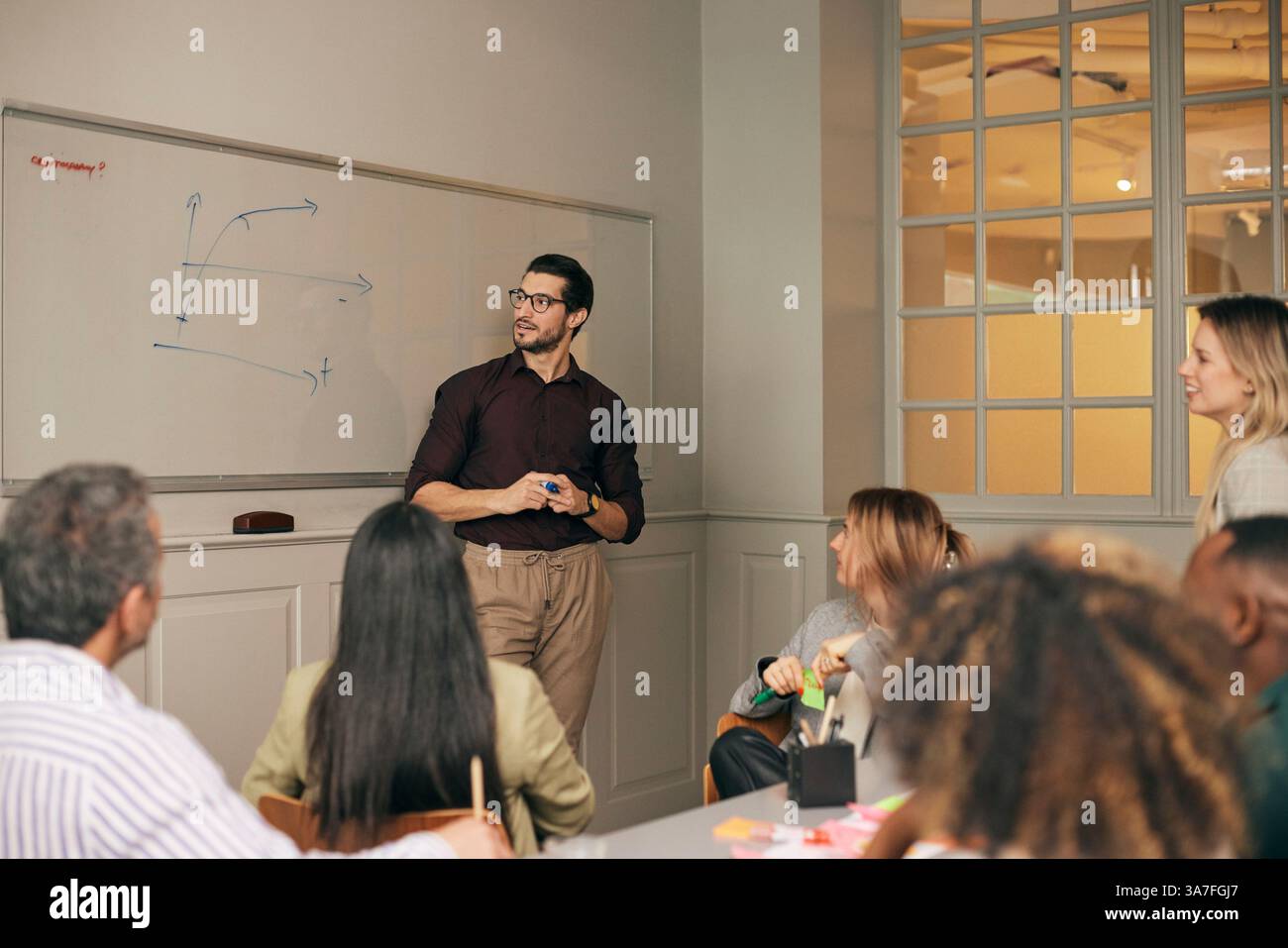 African woman explaining diagrams colleagues hi-res stock photography ...