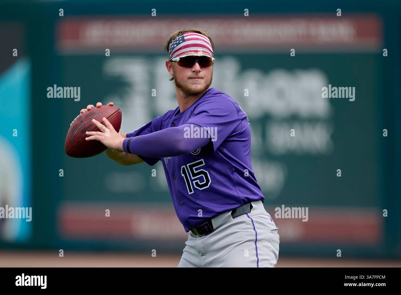 Colorado Rockies catcher Hunter Goodman (15) throwing a football during ...