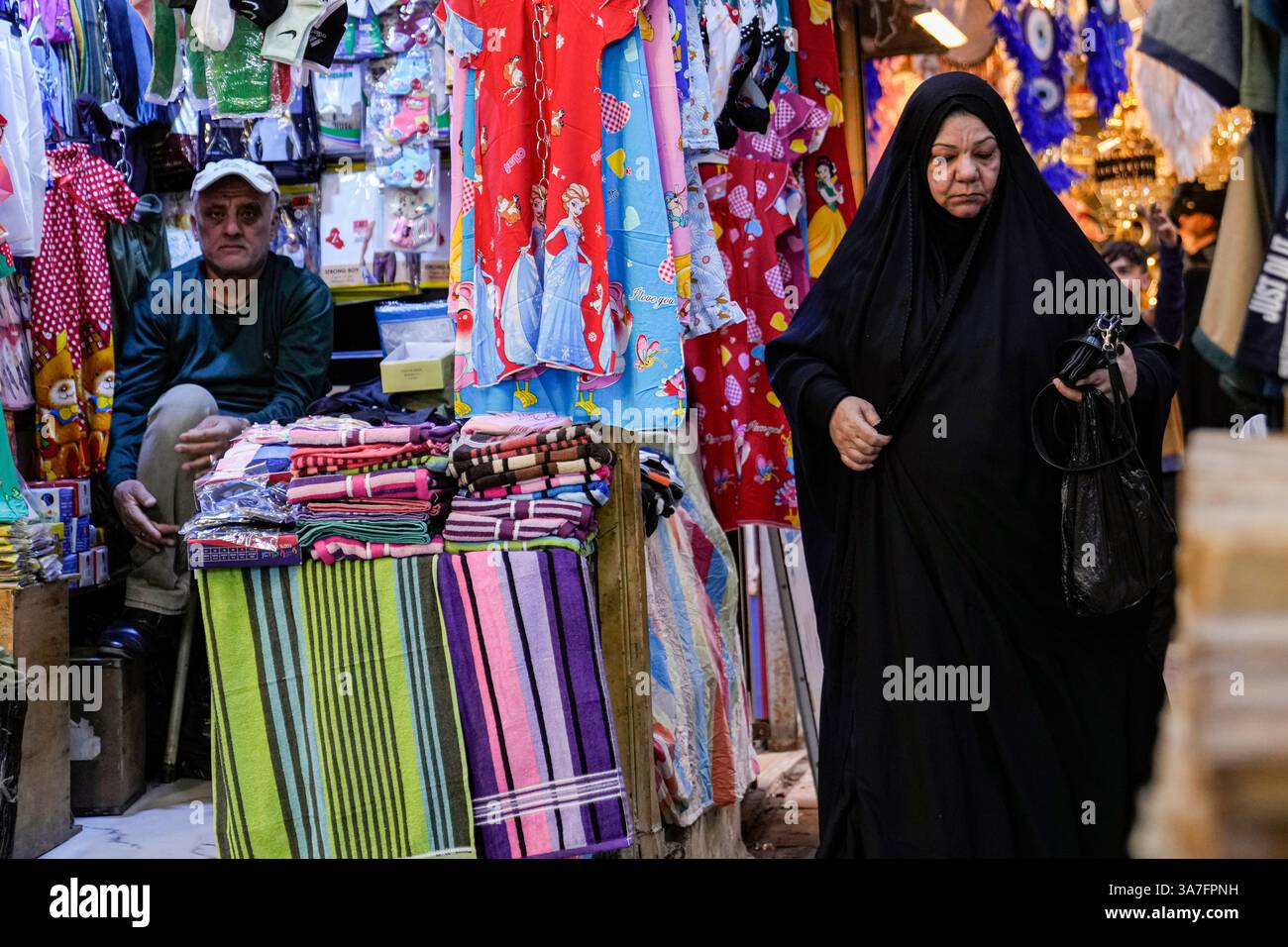 An Iraqi woman shops for clothes ahead of Eid al-Fitr at the Shorjah ...