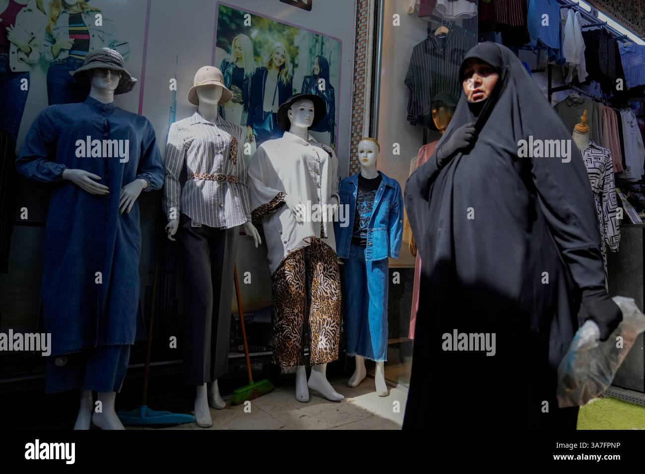 An Iraqi woman shops for clothes ahead of Eid al-Fitr at the Shorjah ...