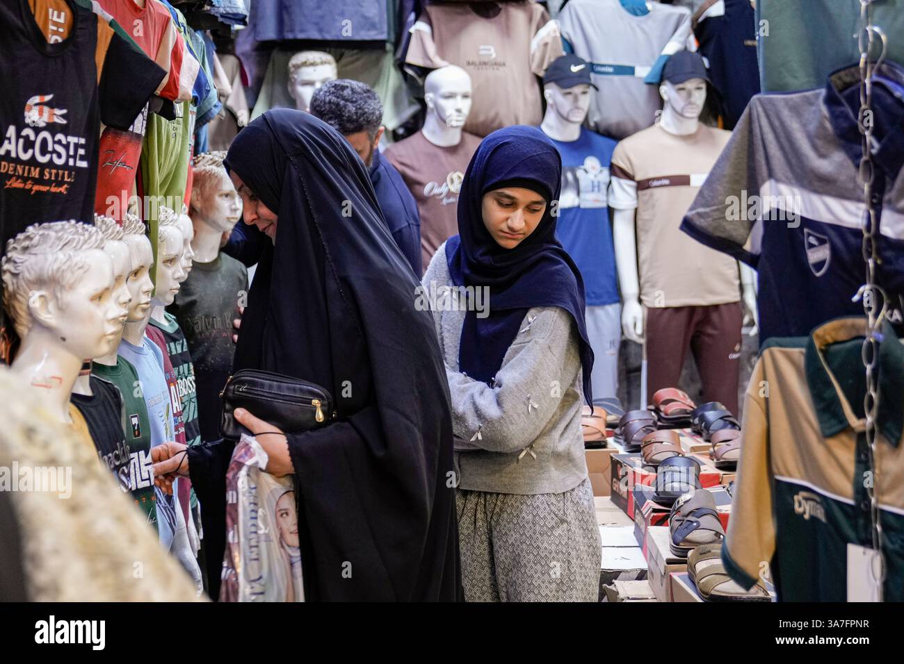 An Iraqi woman shops for clothes ahead of Eid al-Fitr at the Shorjah ...