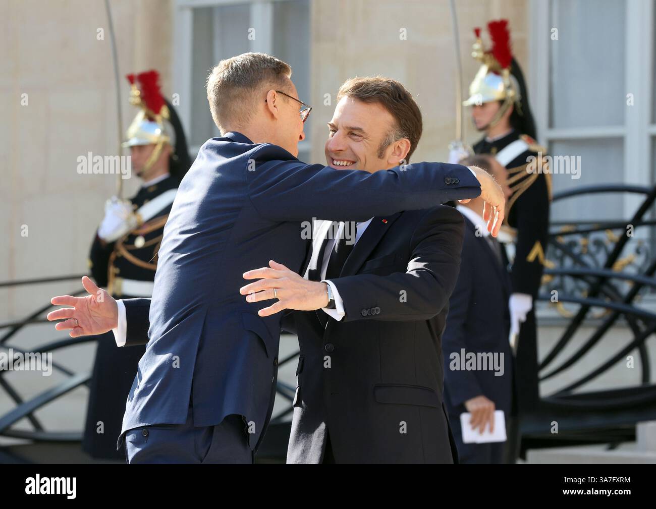 Paris, France. 27th Mar, 2025. French President Emmanuel Macron greets ...