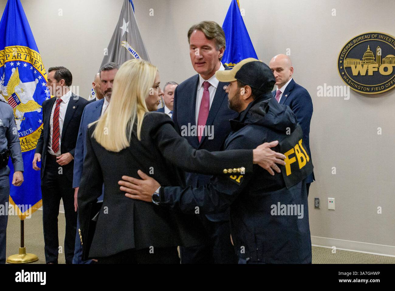 Virginia Gov. Glenn Youngkin, center, looks on as Attorney General Pam ...