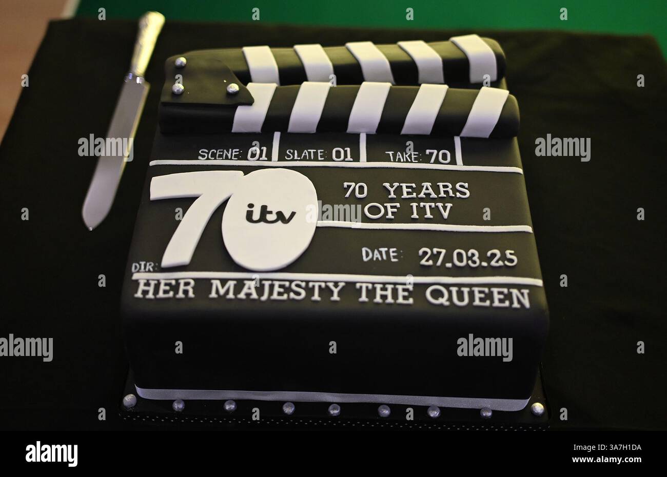 A clapperboard-shaped cake during a reception attended by Queen Camilla ...