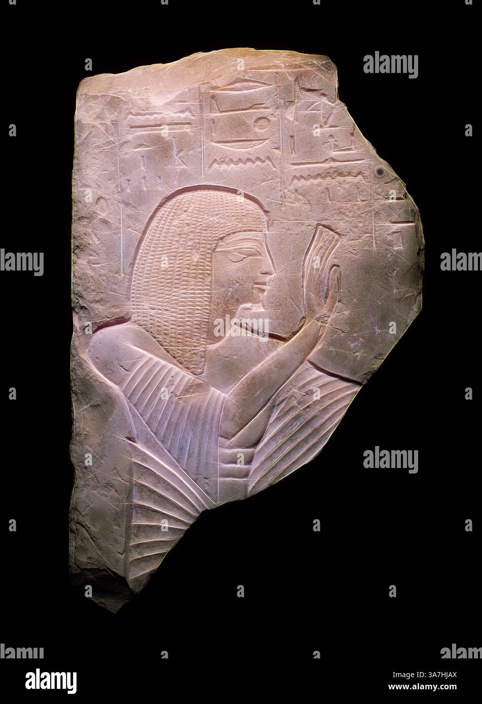 An intricately carved stone relief depicting a figure with detailed ...