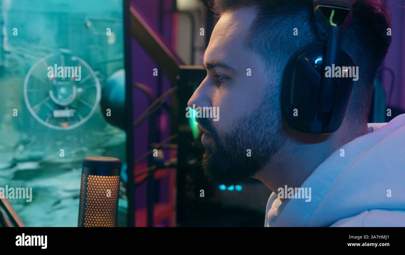 Serious concentrated Caucasian addicted man male guy gamer evening home ...