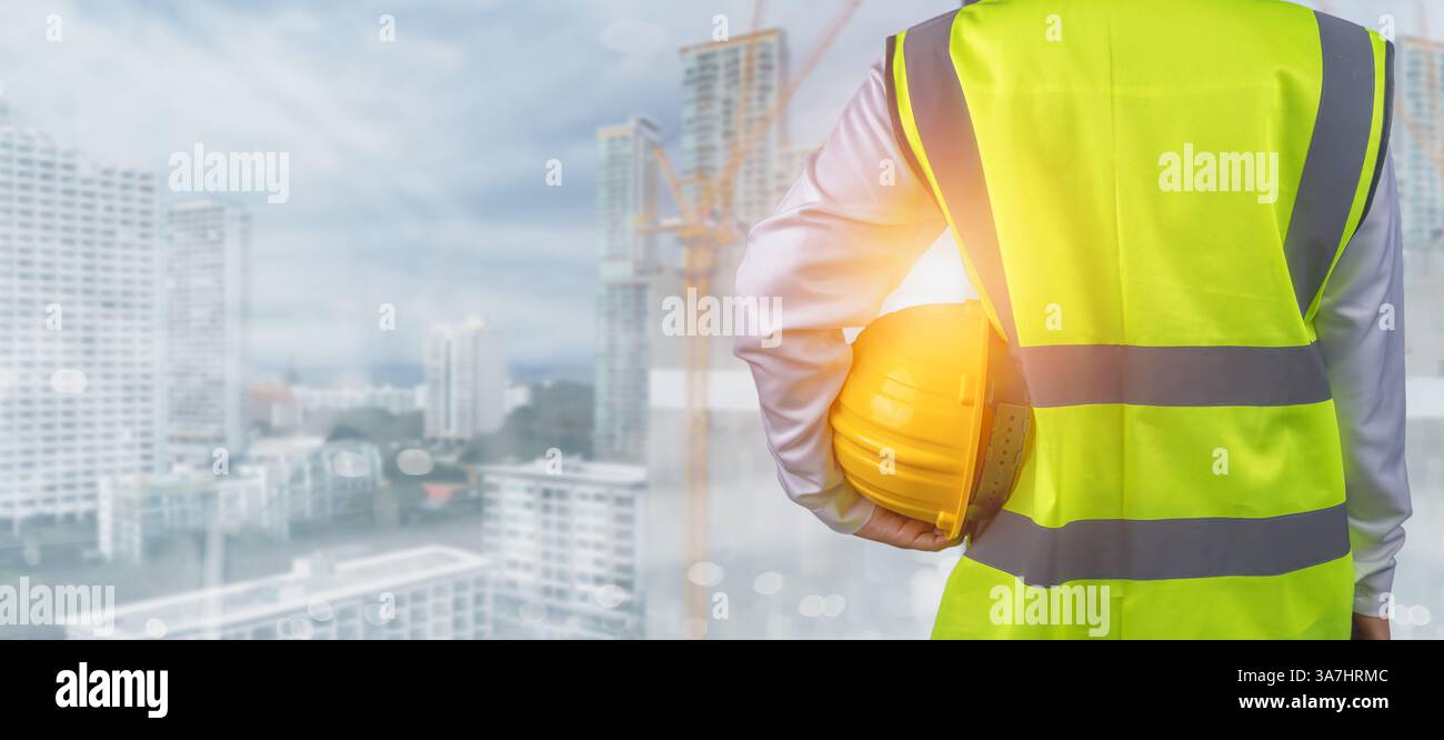 Civil engineer architect standing holding a safety helmet on ...