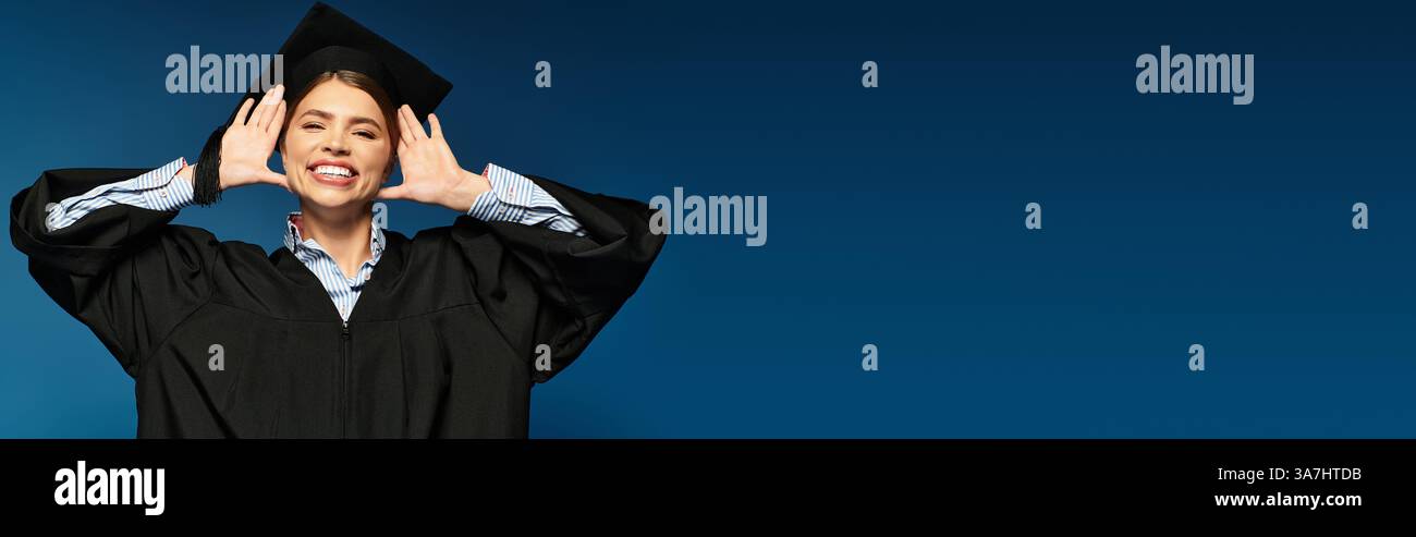 Happy graduate in cap and gown smiles, celebrating her success against ...