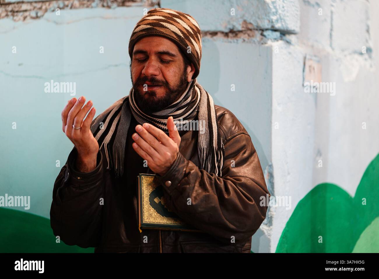 March 27, 2025, Mosul, Nineveh, Iraq: A Sunni Muslim man holds a Quran ...