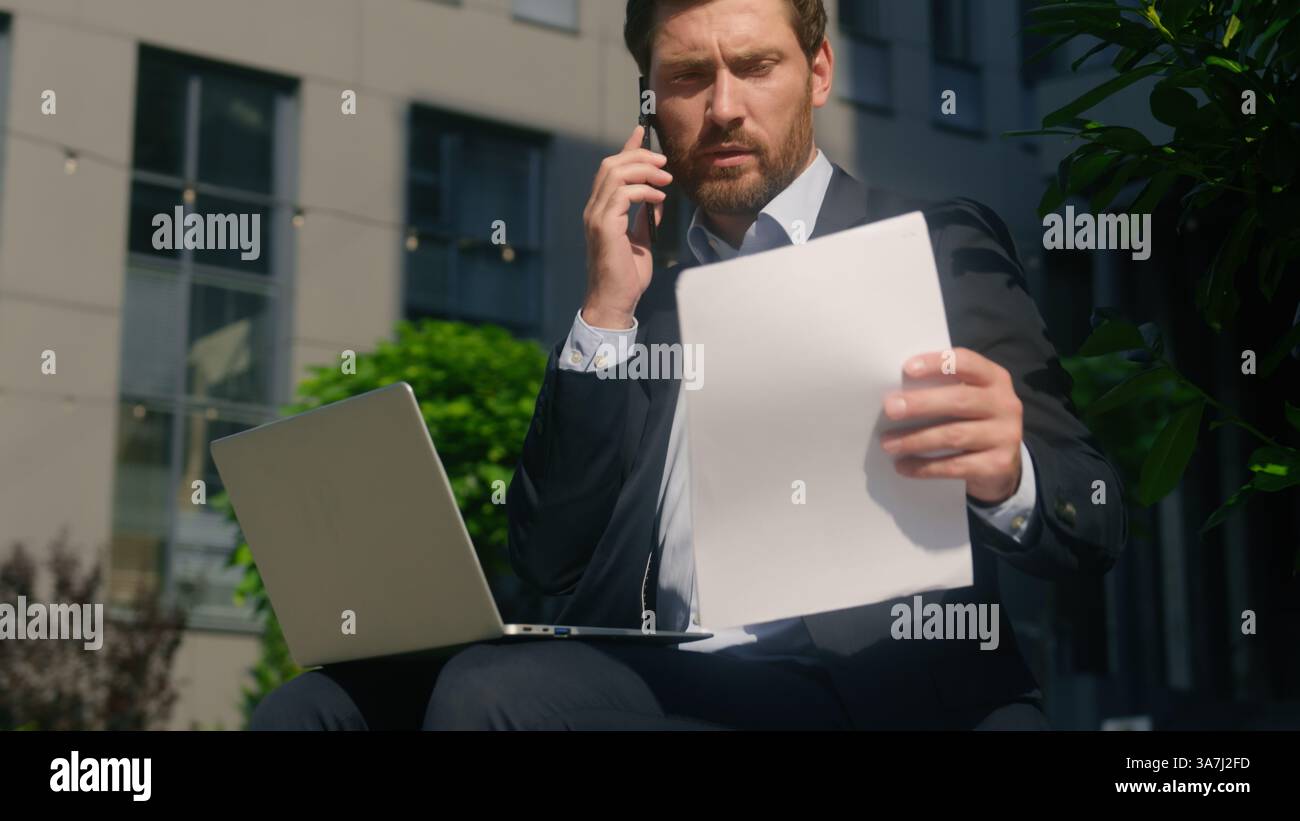 Multitasking busy Caucasian middle-aged businessman business man male guy entrepreneur in city ...