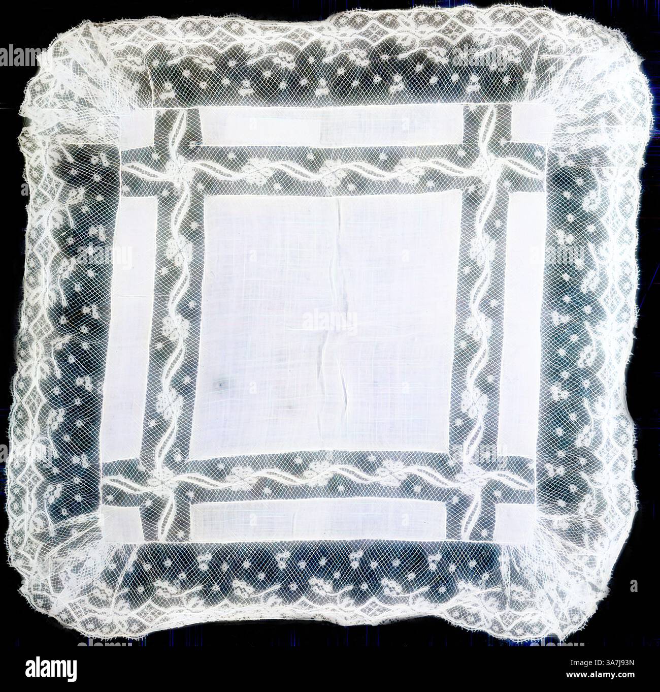 A delicate lace doily featuring intricate patterns and a scalloped edge ...