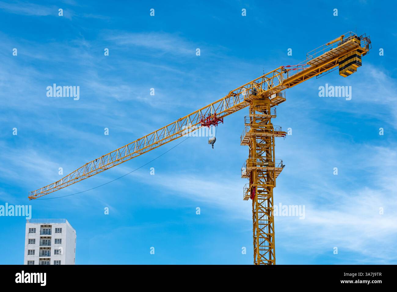 Yellow crane at building construction site. New building construction ...