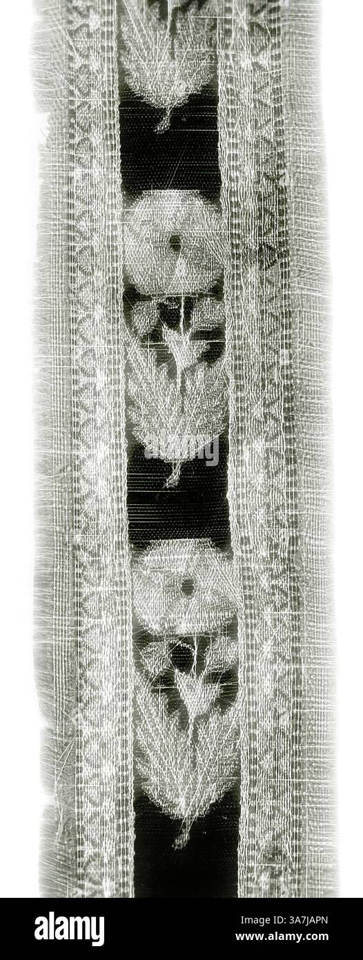 A delicate textile adorns intricate floral and leaf patterns ...