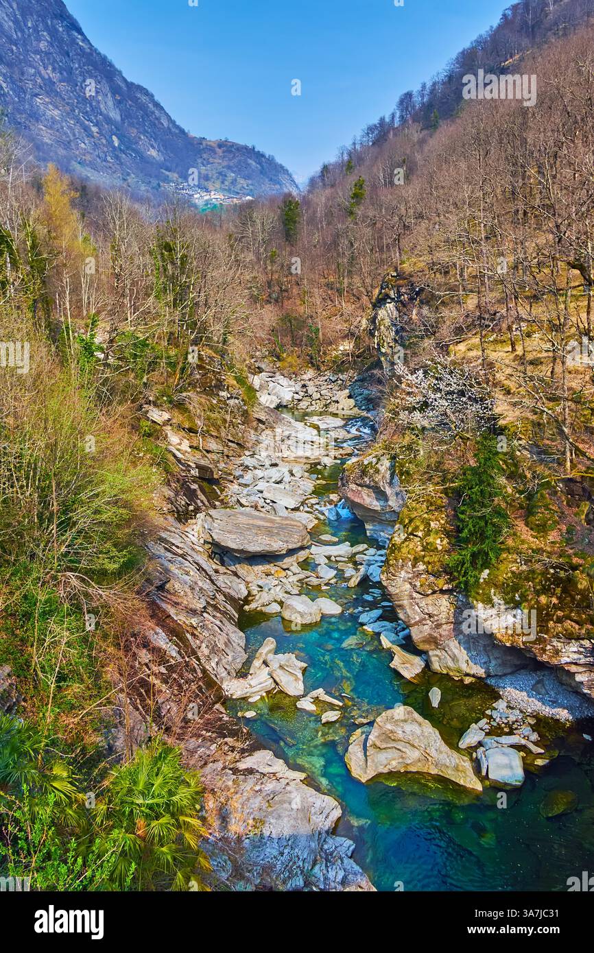 The rocky cliff, covered with thickets, opens the view on the curved ...