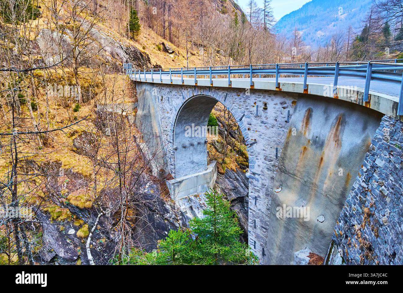 The stone arched bridge spanning the deep, narrow gorge of the Maggia ...