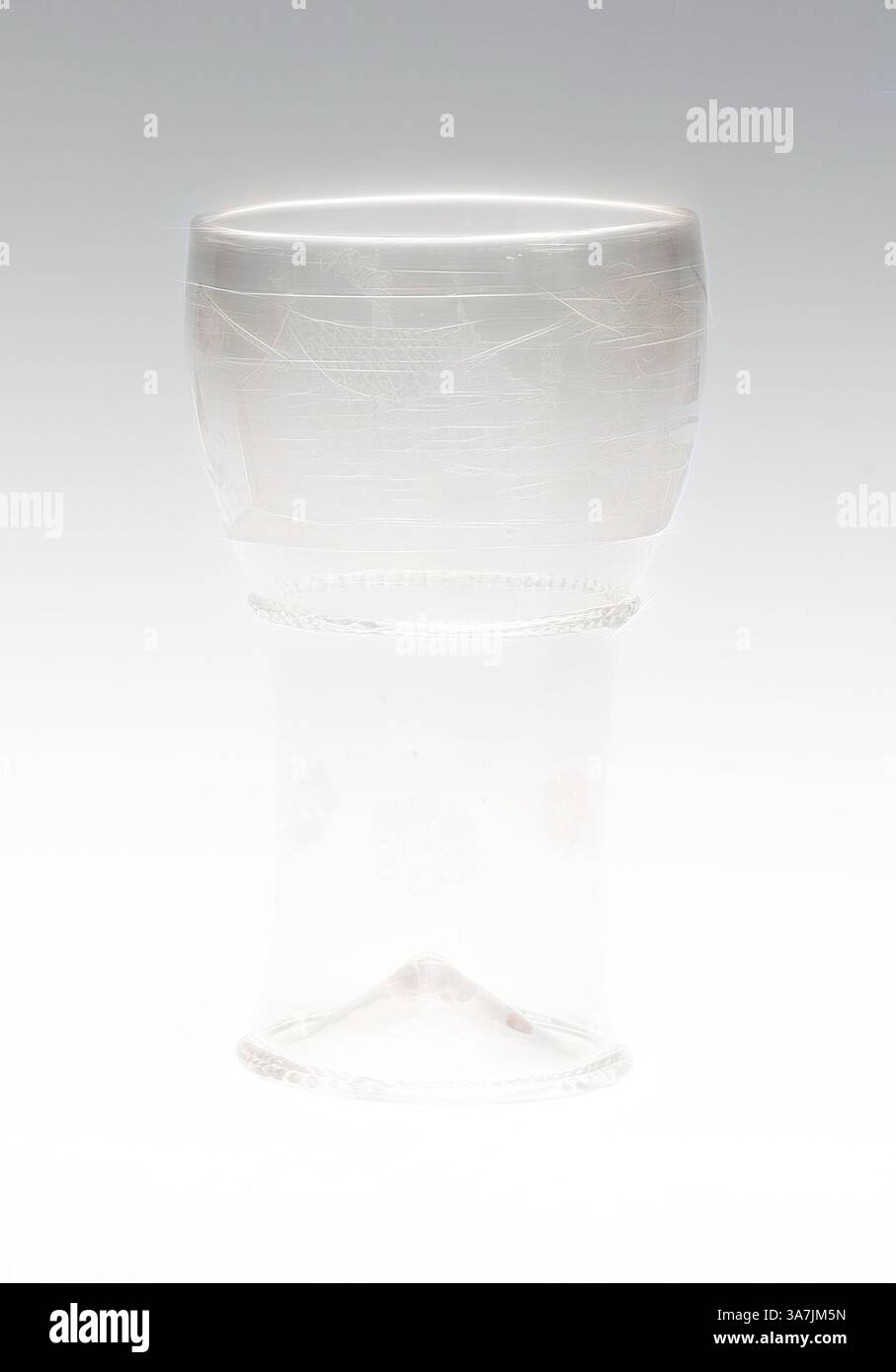 A clear, delicately shaped glass vessel with subtle textures and an ...