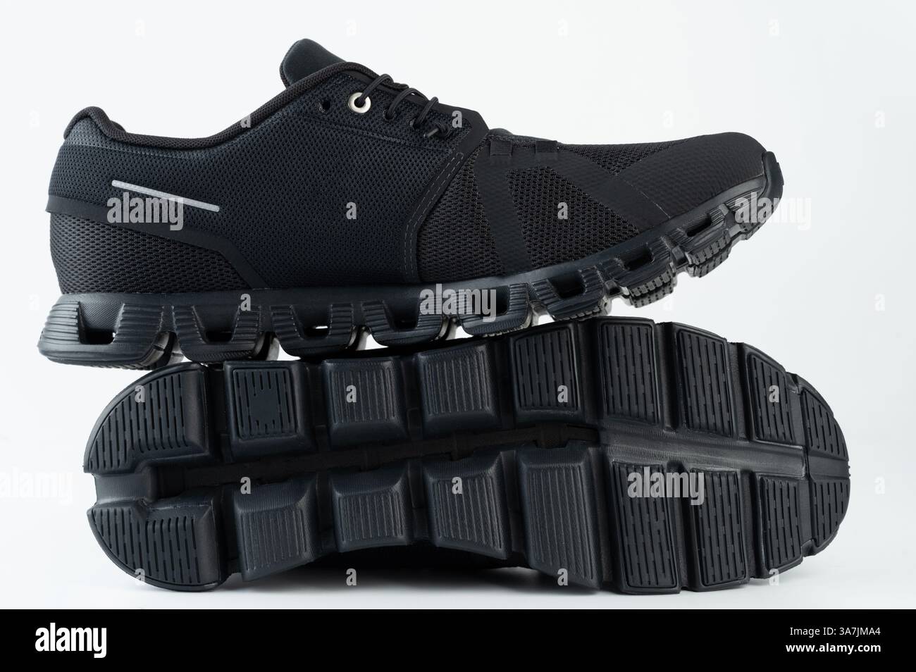 Modern black sport pair shoes side sole view isolated on studio ...